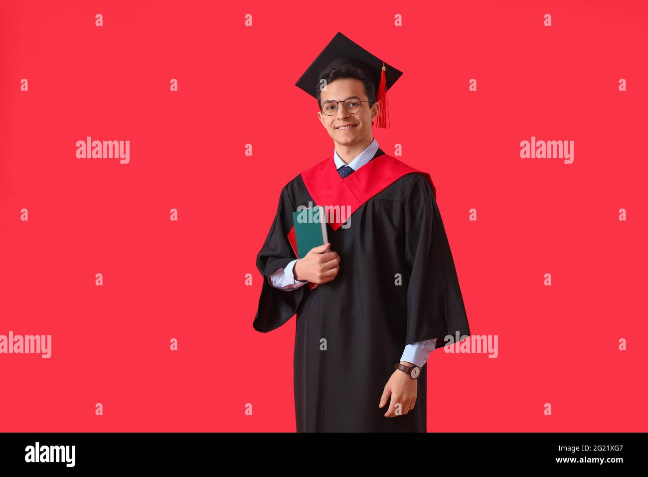 Male graduating student on color background Stock Photo - Alamy