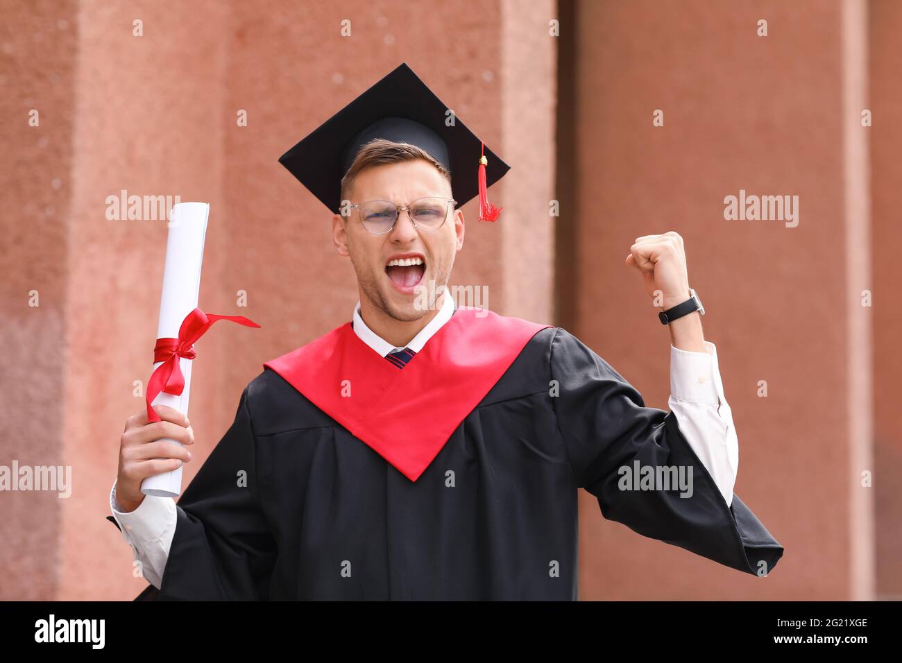Portrait of happy male graduating student outdoors Stock Photo - Alamy