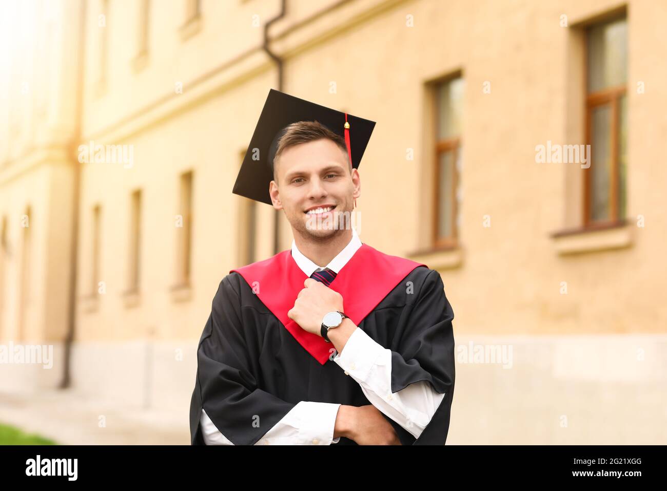 Portrait of male graduating student outdoors Stock Photo - Alamy