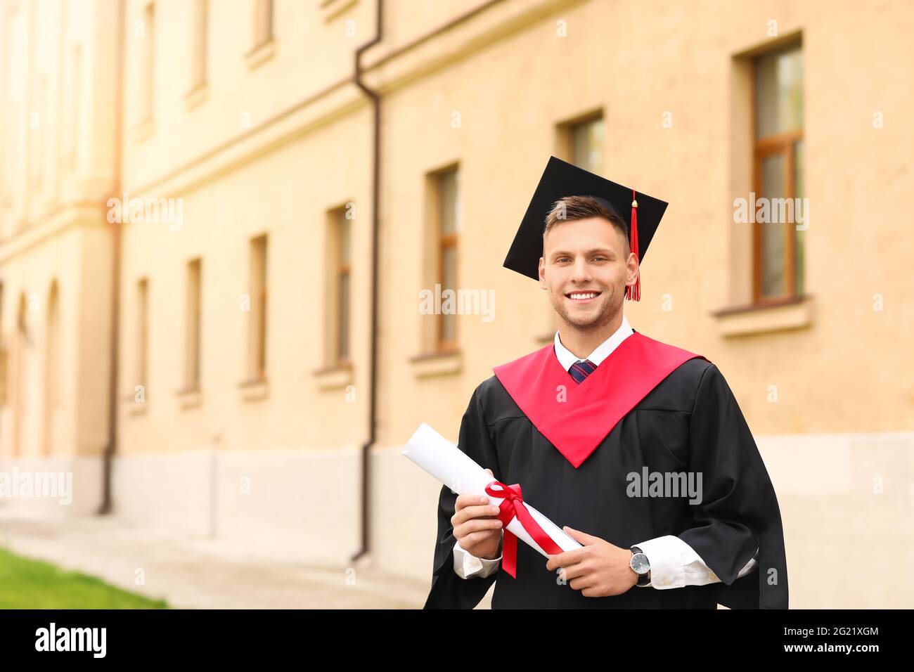 Portrait of male graduating student outdoors Stock Photo - Alamy