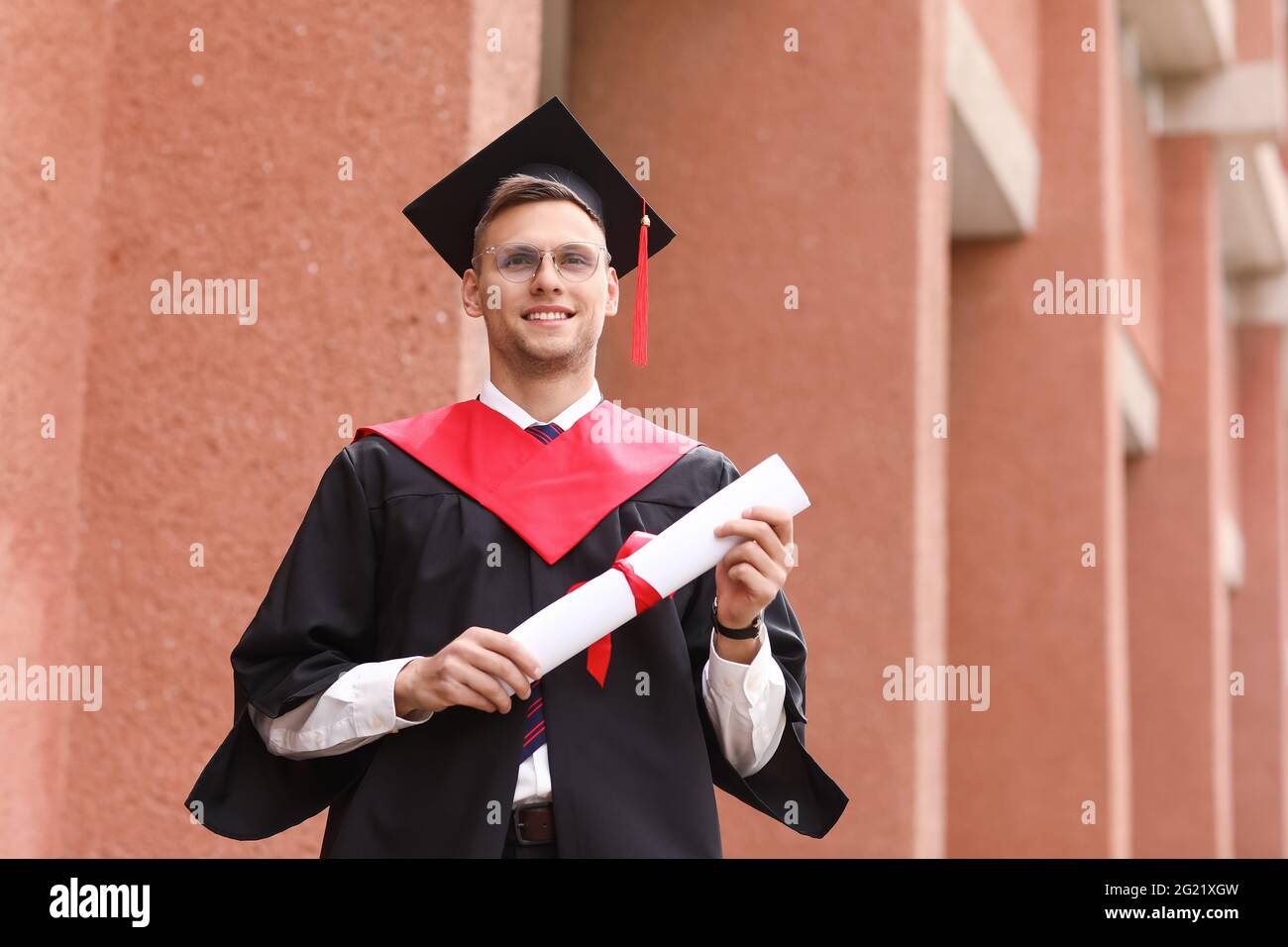 Portrait of male graduating student outdoors Stock Photo - Alamy