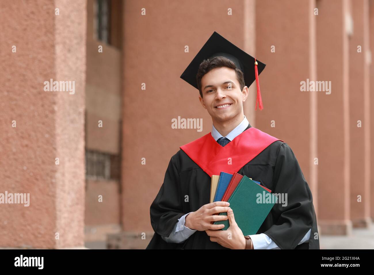 Portrait of male graduating student outdoors Stock Photo - Alamy