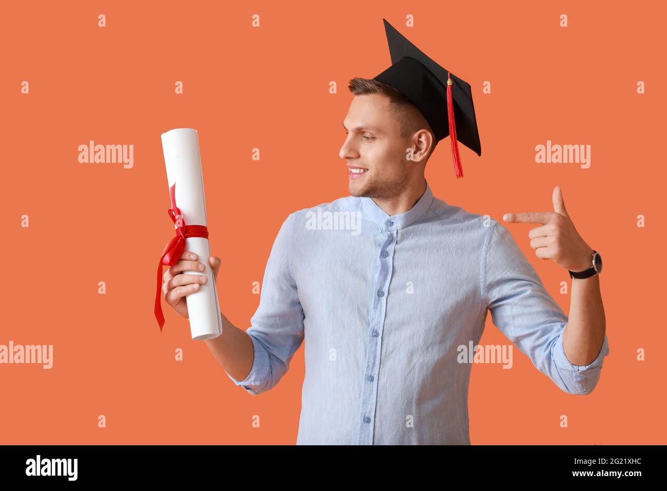 Male graduating student on color background Stock Photo - Alamy