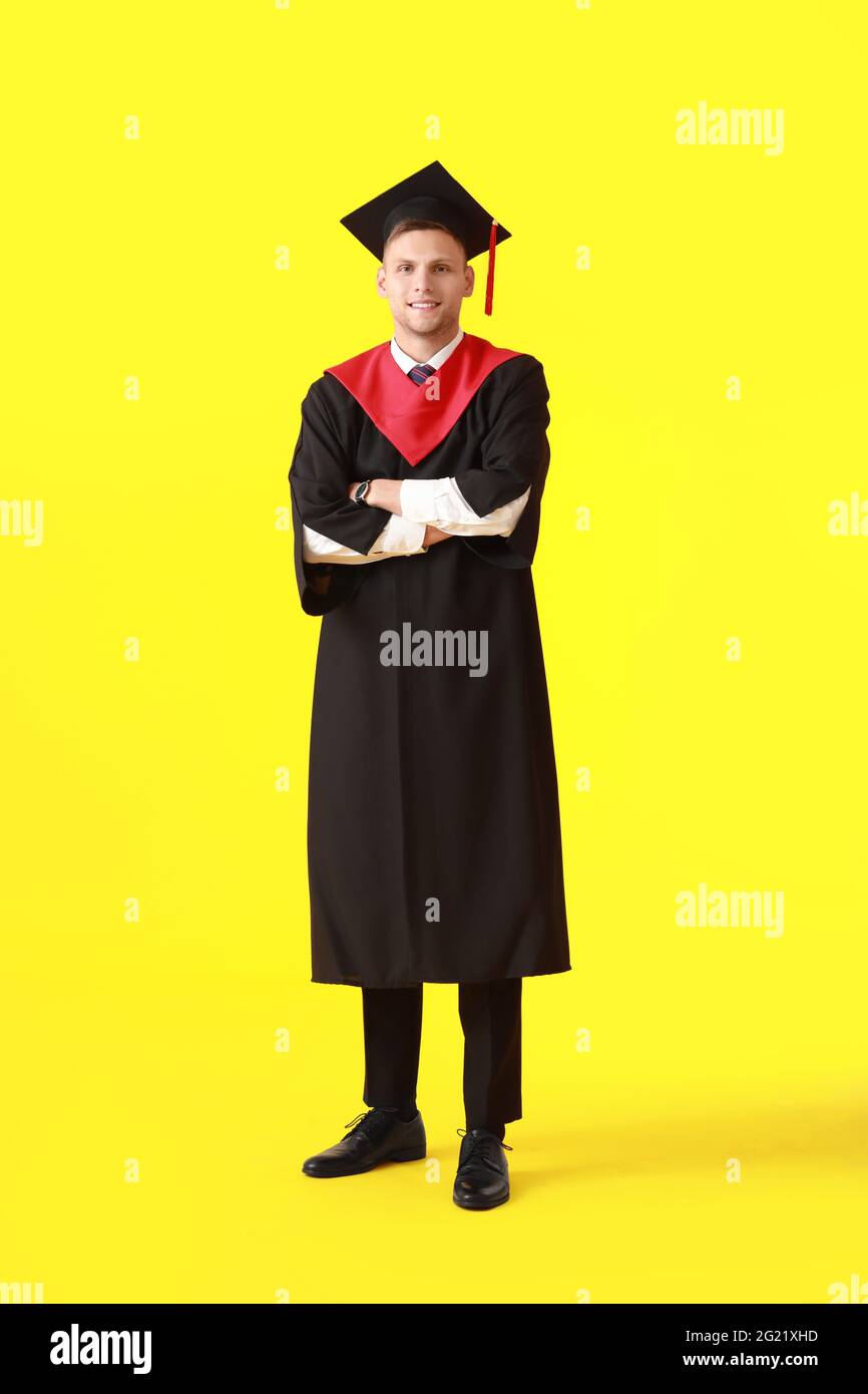 Male graduating student on color background Stock Photo - Alamy
