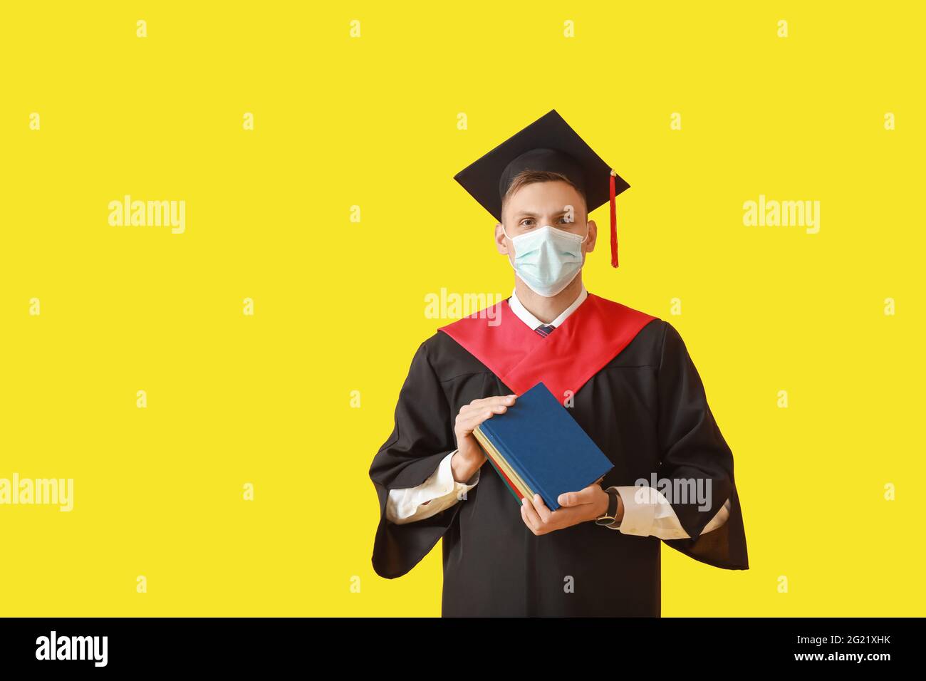 Male graduating student on color background Stock Photo - Alamy