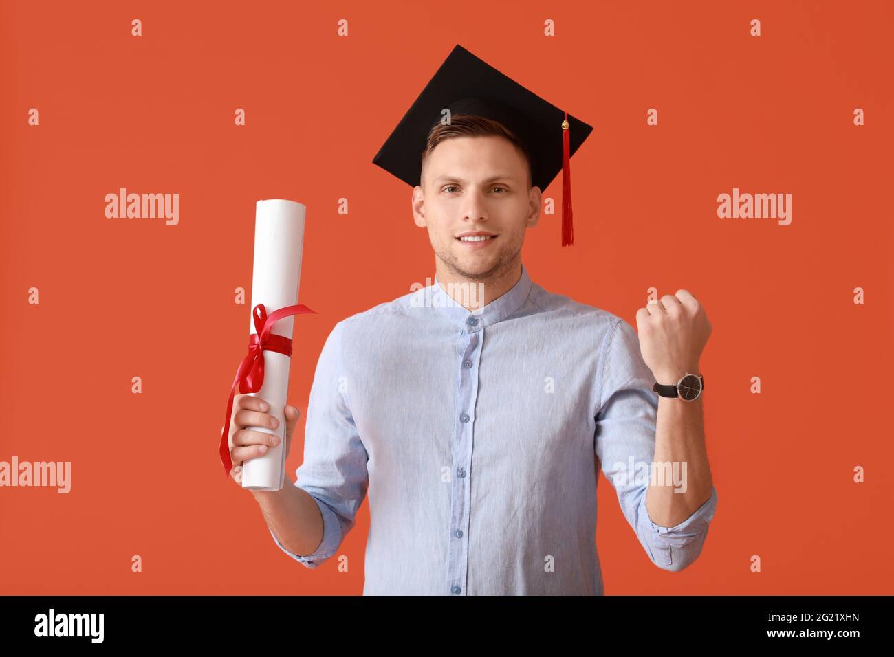 Happy graduating student on color background Stock Photo - Alamy