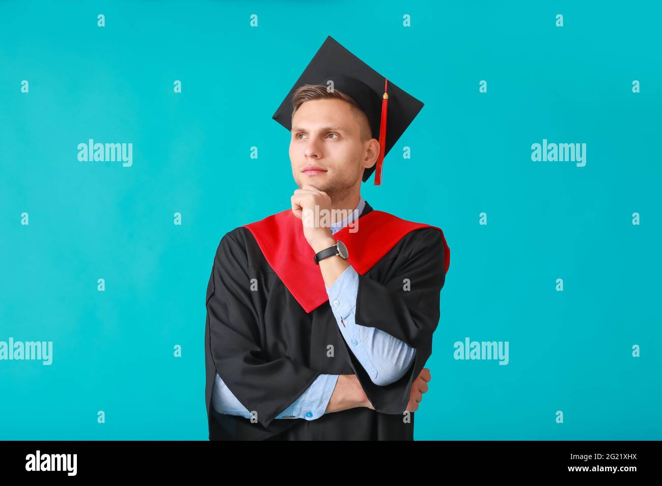 Male graduating student on color background Stock Photo - Alamy