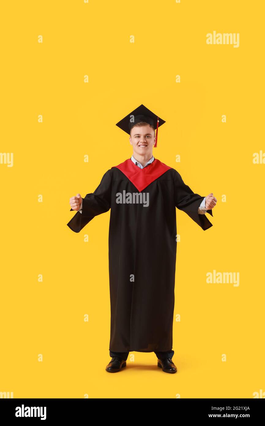 Happy graduating student on color background Stock Photo - Alamy