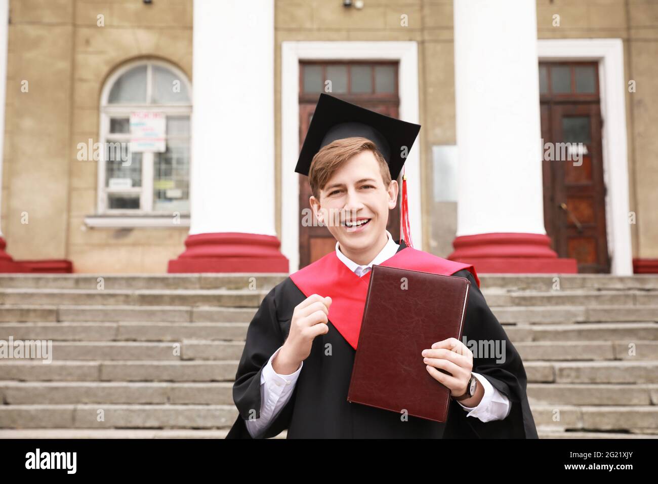 Portrait of male graduating student outdoors Stock Photo - Alamy