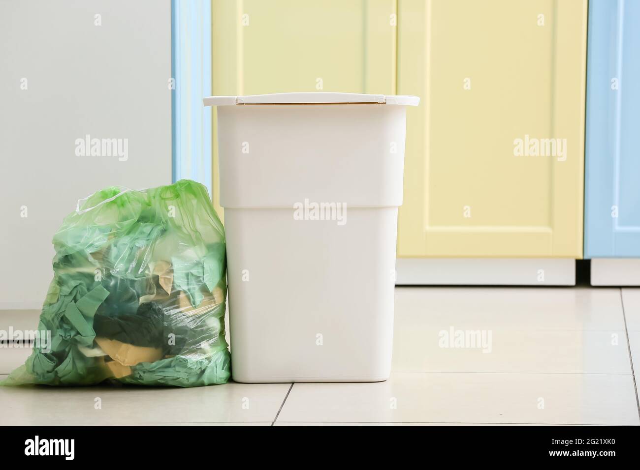 Bag with garbage and rubbish bin at home Stock Photo - Alamy