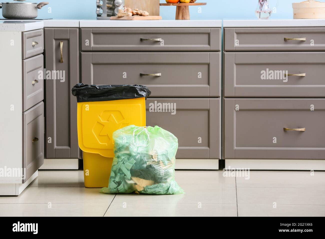 Bag with garbage and rubbish bin with logo of recycling at home Stock ...