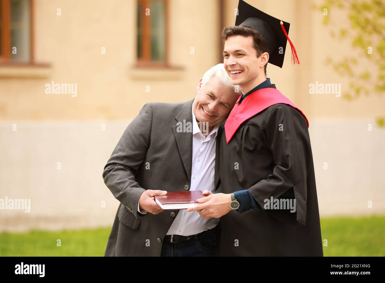 Father hugging son at graduation hi-res stock photography and images ...