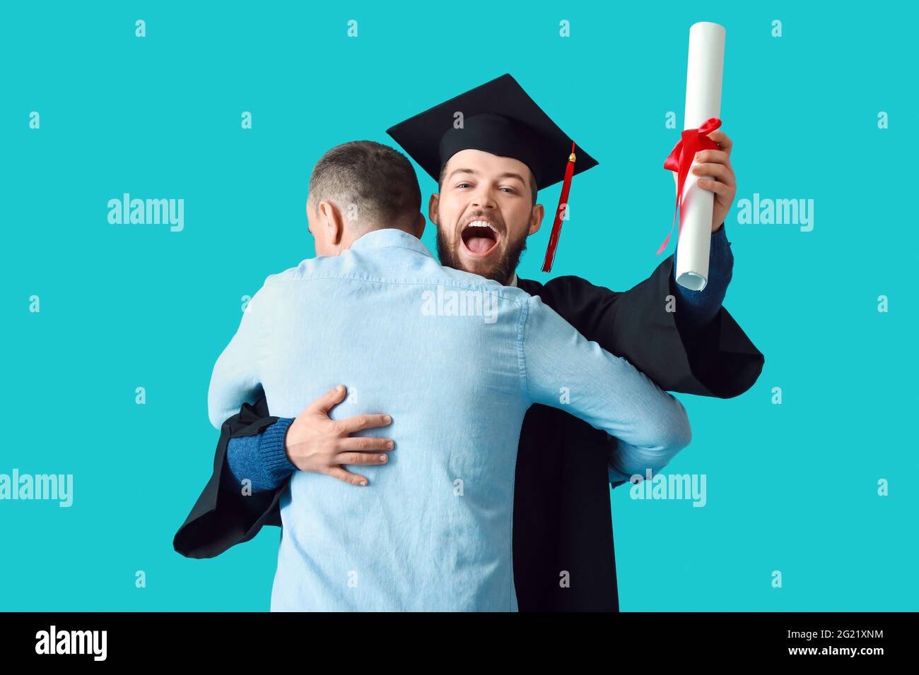 Father hugging son at graduation hi-res stock photography and images ...