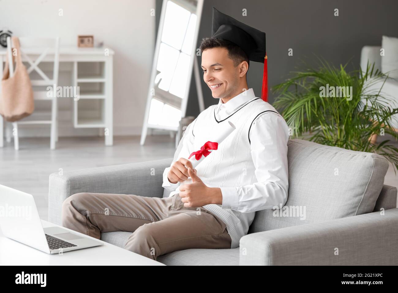 Happy male student on his graduation day at home. Concept of online ...