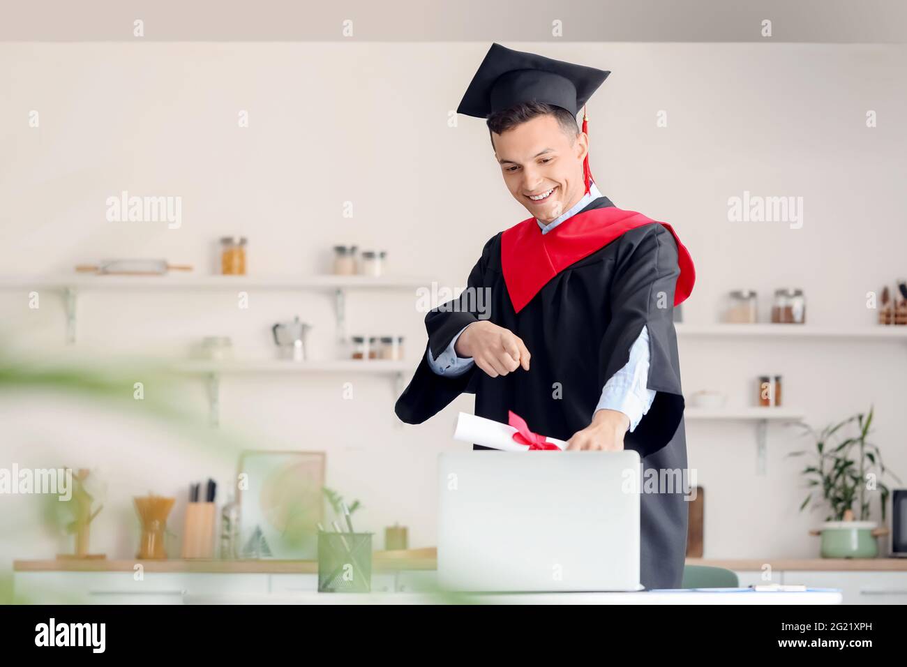 Happy male student on his graduation day at home. Concept of online ...