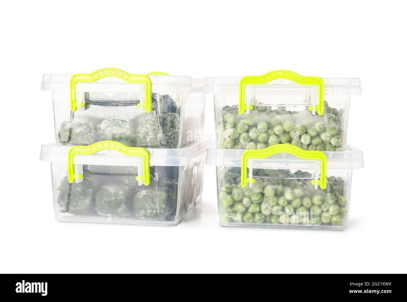 Plastic containers with frozen spinach and green peas on white ...