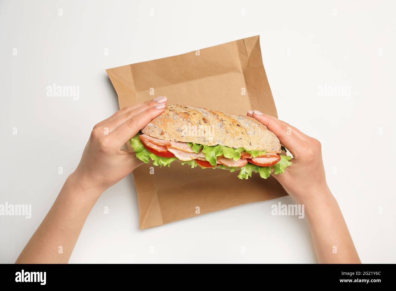 Female hands with tasty ciabatta sandwich on white background Stock ...