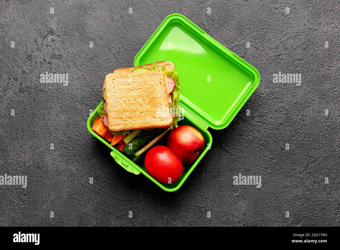 Lunch box with tasty food on dark background Stock Photo - Alamy