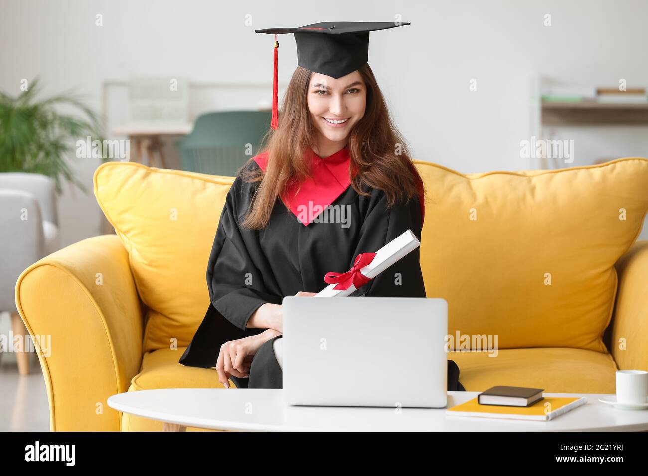 Happy female student on her graduation day at home. Concept of studying ...