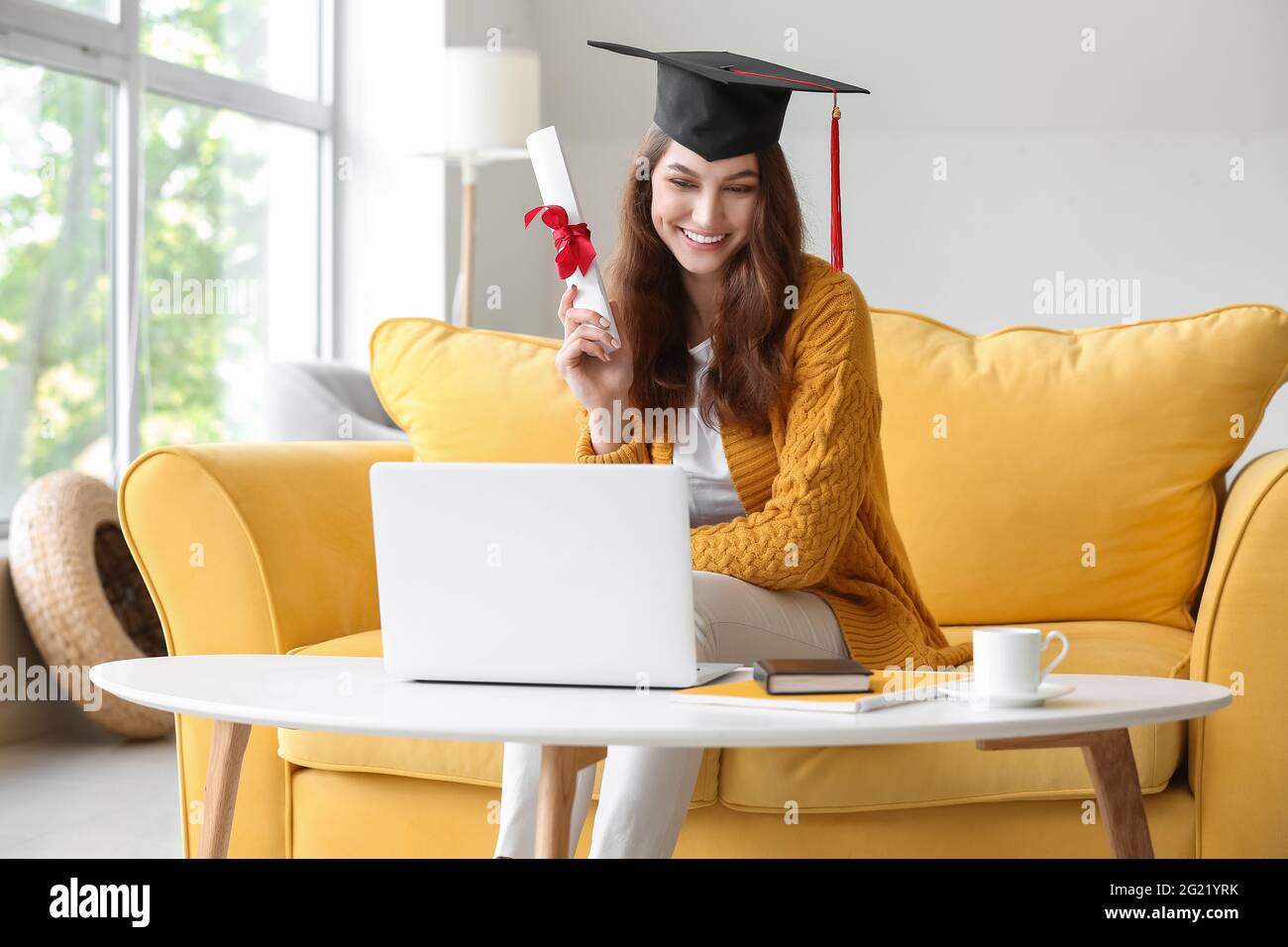 Happy female student on her graduation day at home. Concept of studying ...