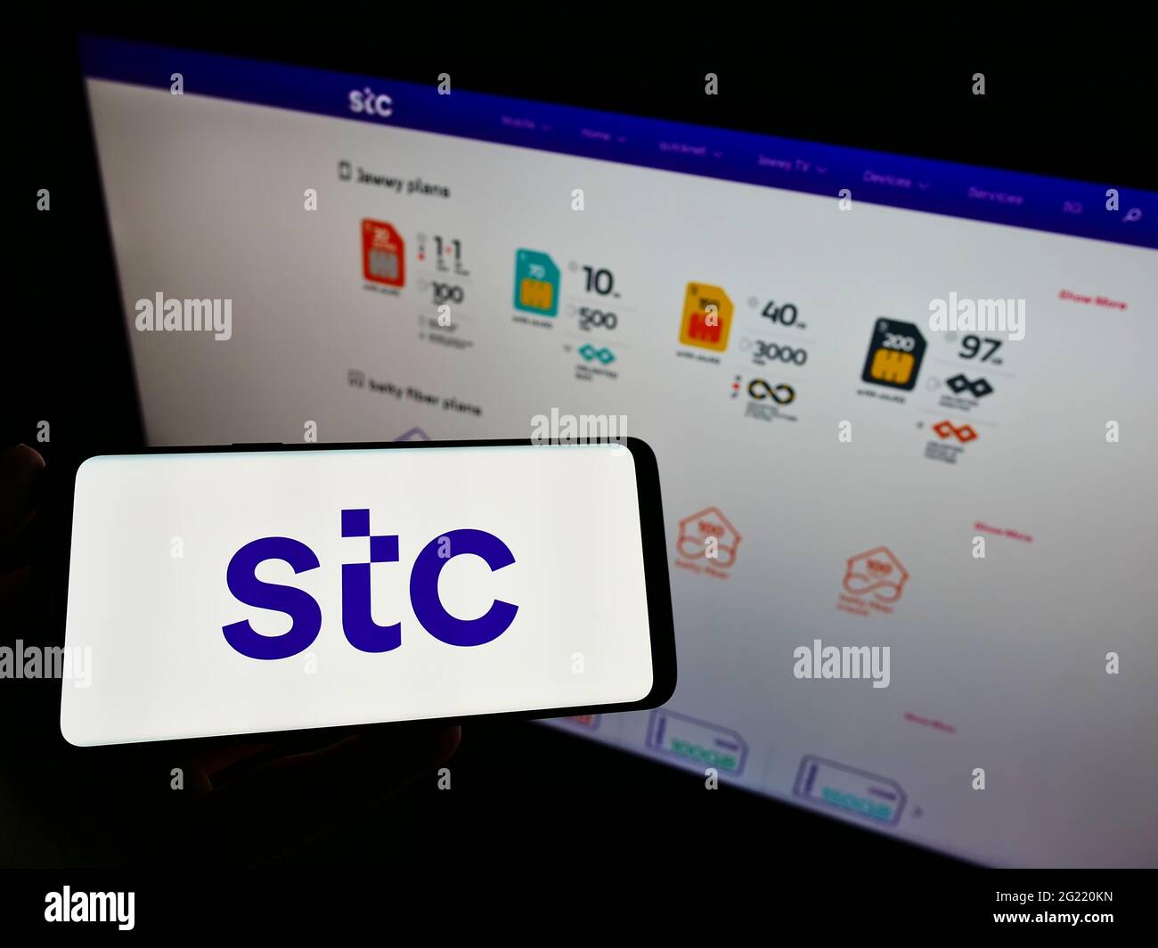 Person holding cellphone with logo of Arabian carrier Saudi Telecom ...