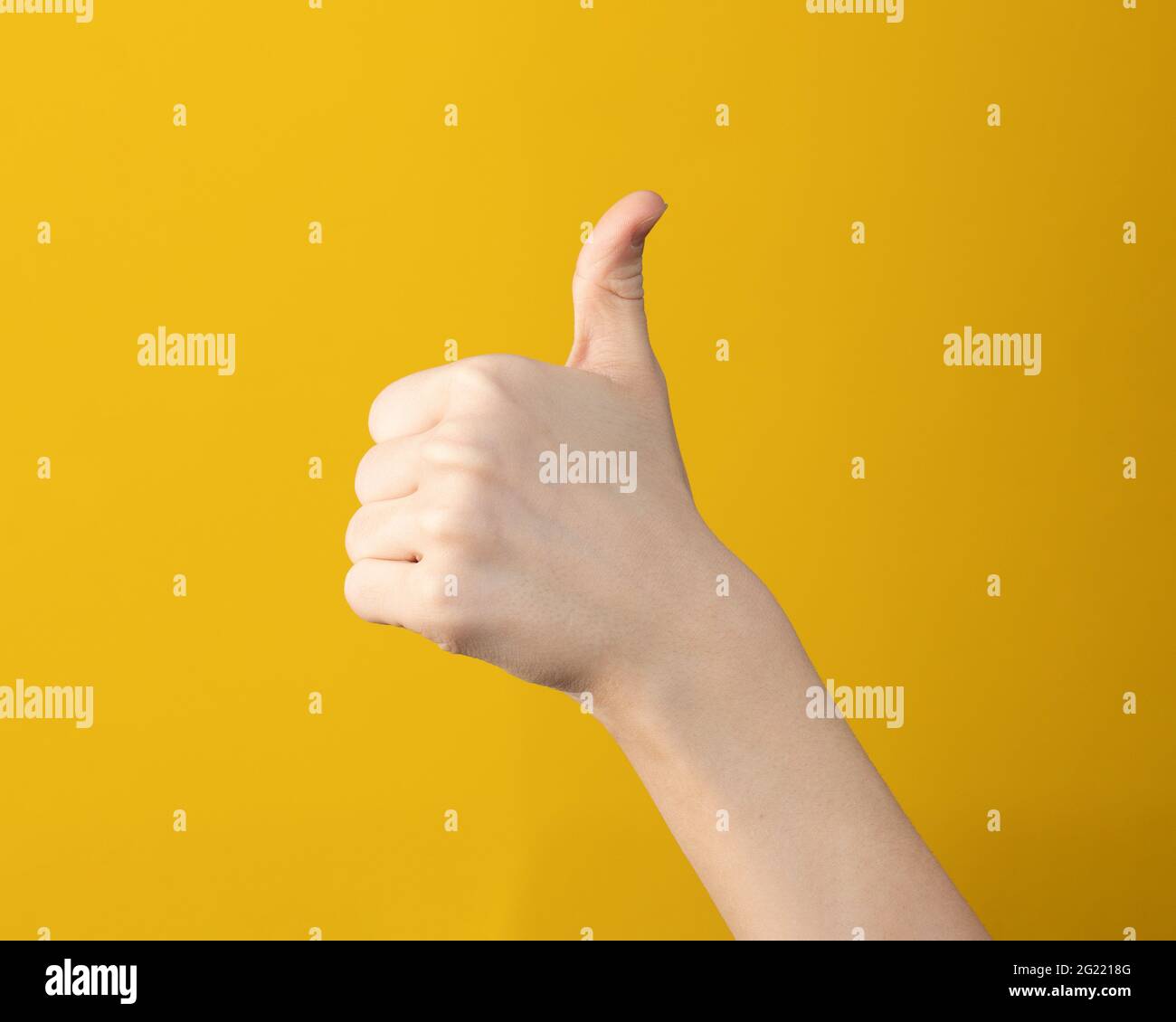 hand gesture with closed fist held with and thumb extended upward on ...