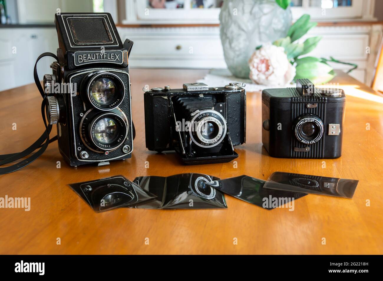 Three vintage retro cameras, a Beautyflex, a Zeiss and a Bullseye, on a ...