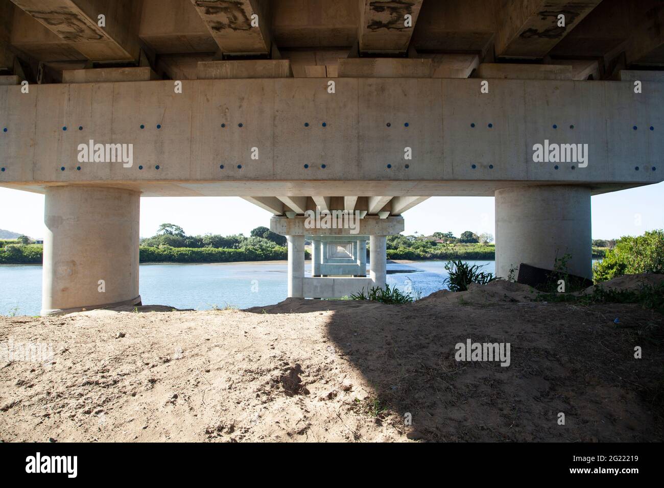 Underneath a newly constructed of reinforced concrete across a river ...