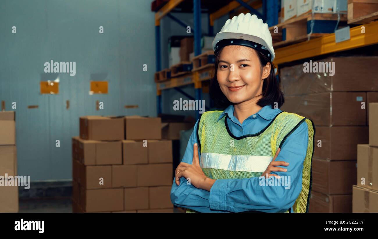 Portrait of young Asian woman warehouse worker smiling in the ...