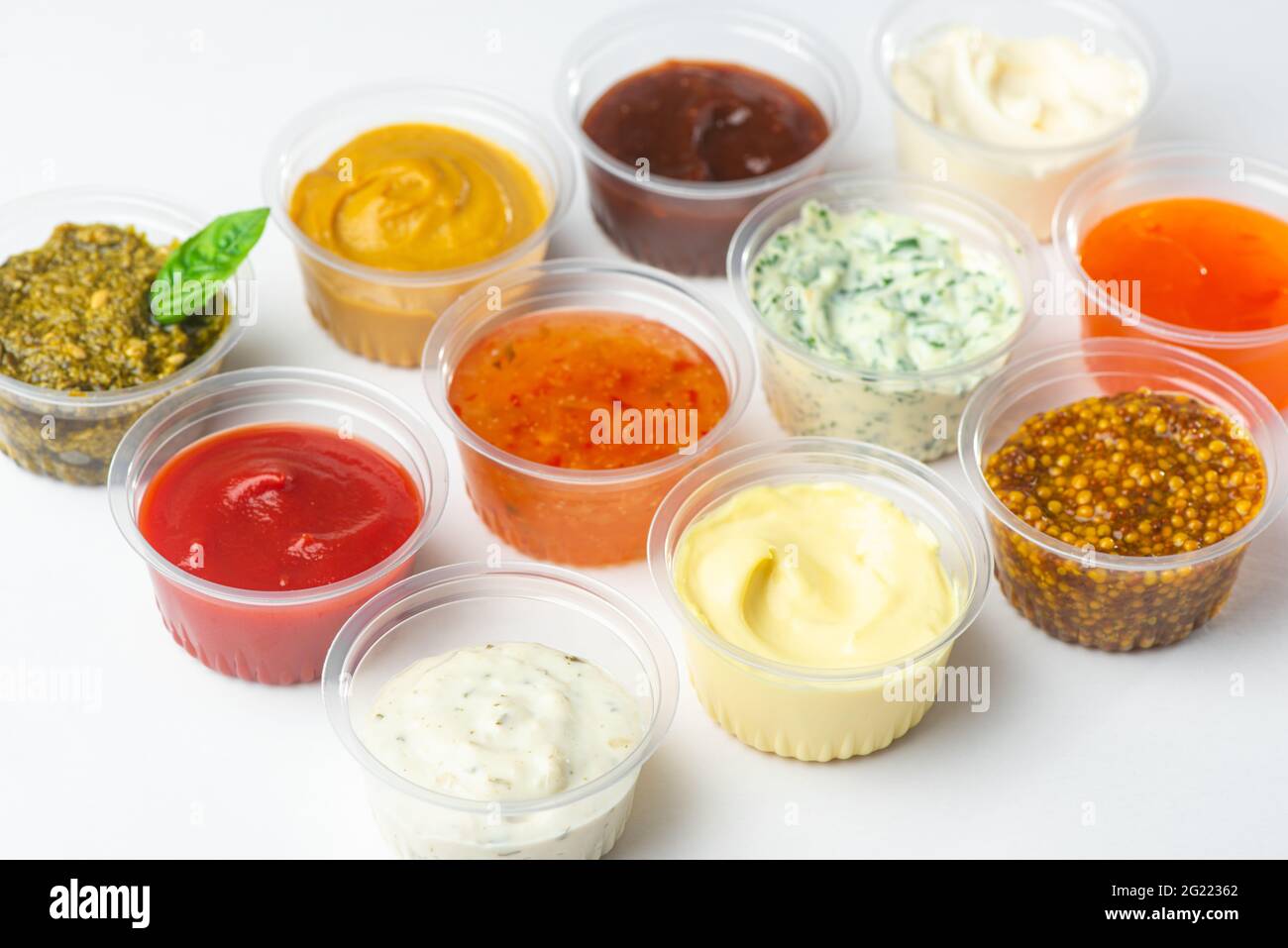 Set of cups of various sauces and condiments for dipping on white ...