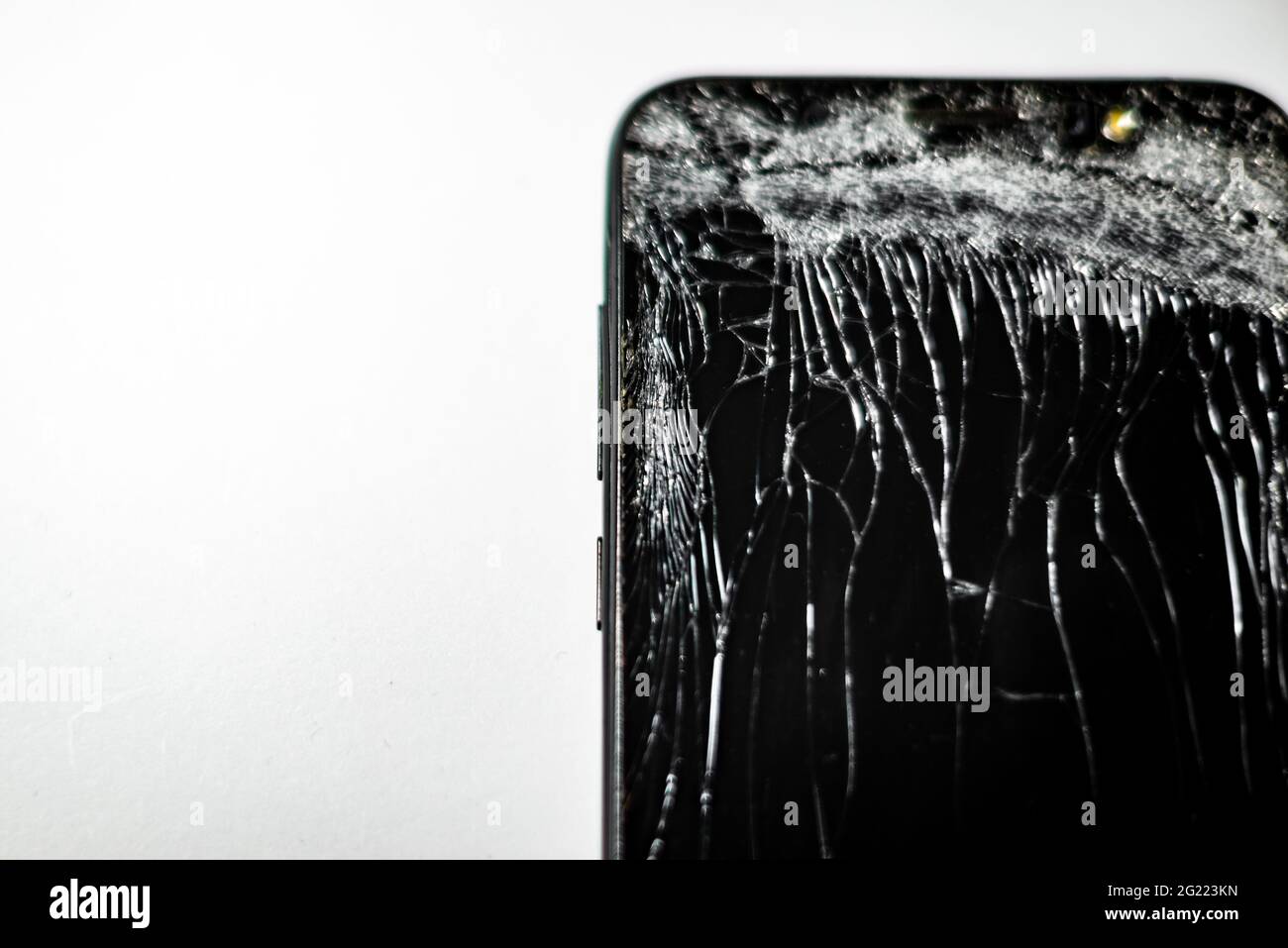Mobile phone with broken screen on white background.Closeup.Copy space ...