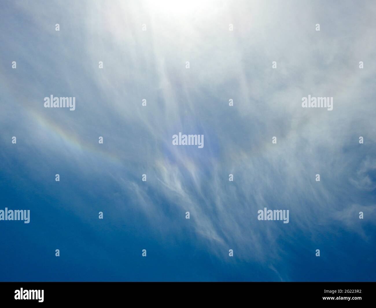 Rainbow circle around the sun in the blue sky Stock Photo - Alamy