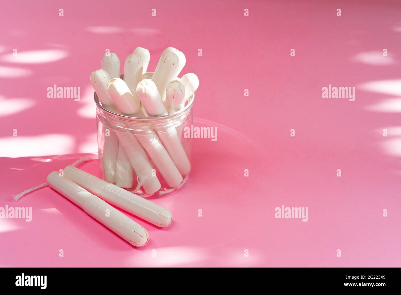 Feminine hygienic tampons on pink paper background Stock Photo - Alamy