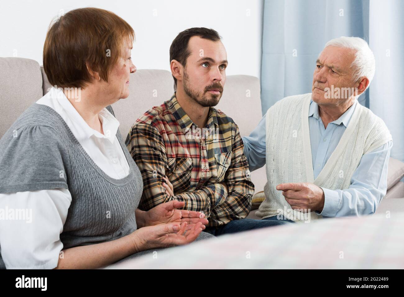 Parents arguing with son Stock Photo - Alamy