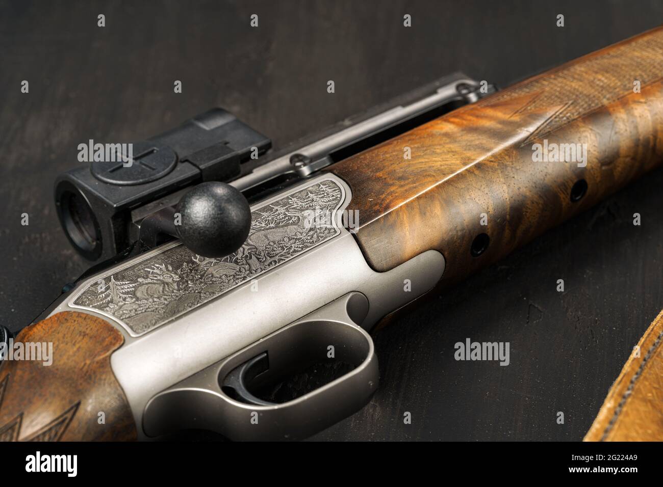 Metal trigger on hunting gun on black background Stock Photo - Alamy