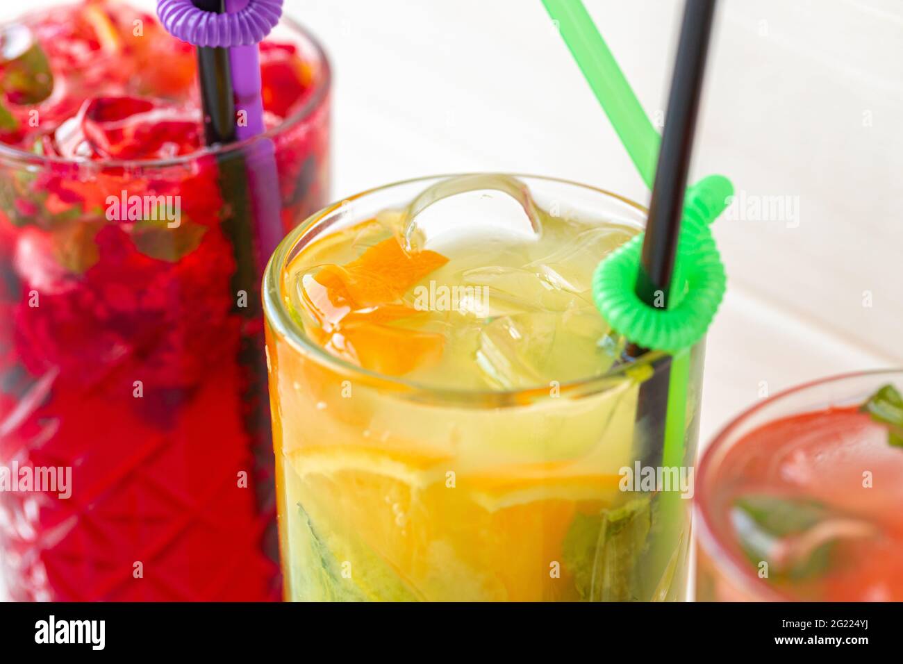 Three different refreshing lemonades on white wooden background Stock ...