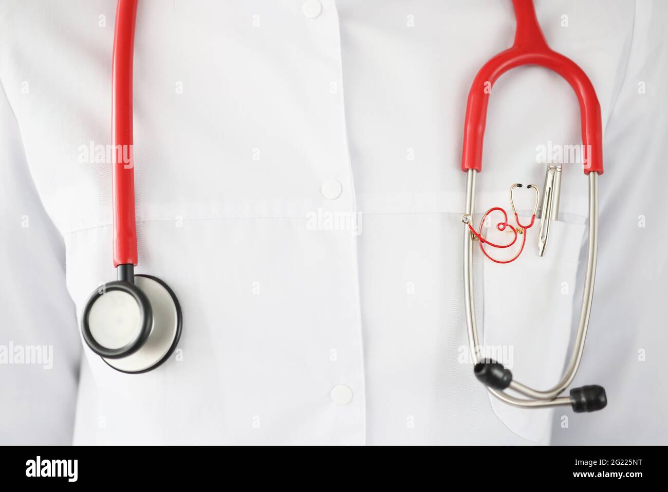 Red stethoscope hanging on doctor neck closeup Stock Photo - Alamy