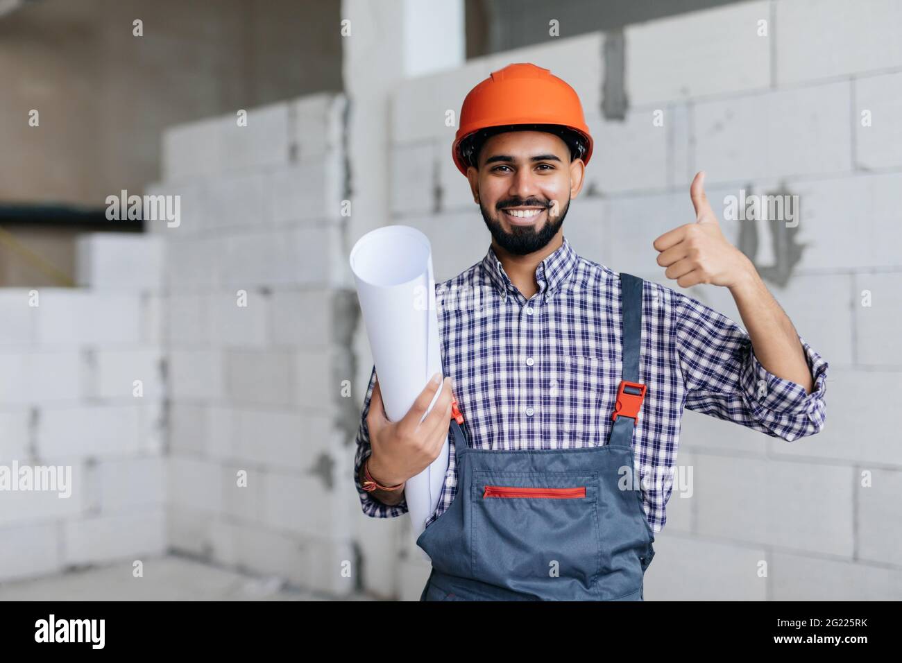 Engineer holds a thumbs up standing at construction site Stock Photo ...
