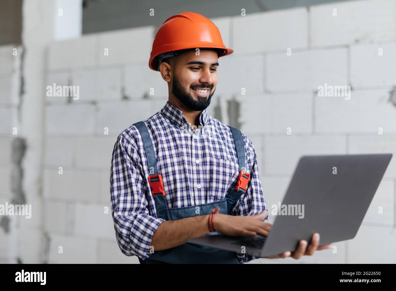 Portrait of development supervisor wearing protective vest and helmet ...