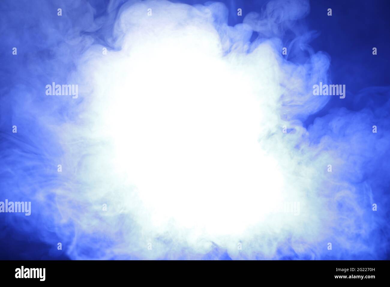 Magic smoke in blue light on black background Stock Photo - Alamy