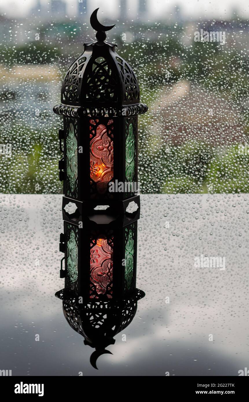 Lantern that have moon symbol on top put on window with rain drop for ...