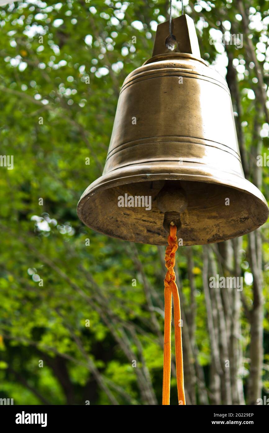 Tradition buddhist wishing bell with green leaves background Stock ...