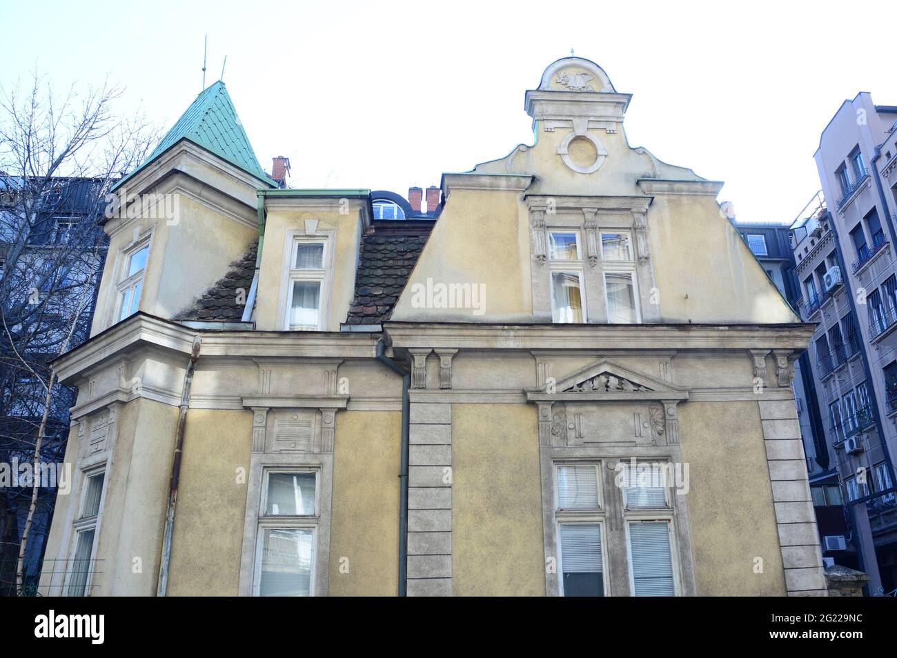 an old architecture house among new architecture buildings Stock Photo ...