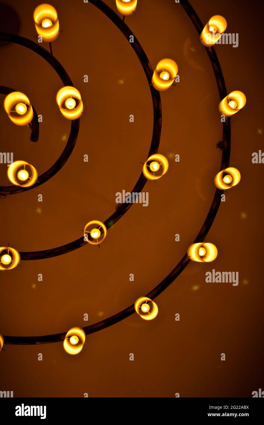 Ceiling lamps hanging on long cords in curve lines Stock Photo - Alamy