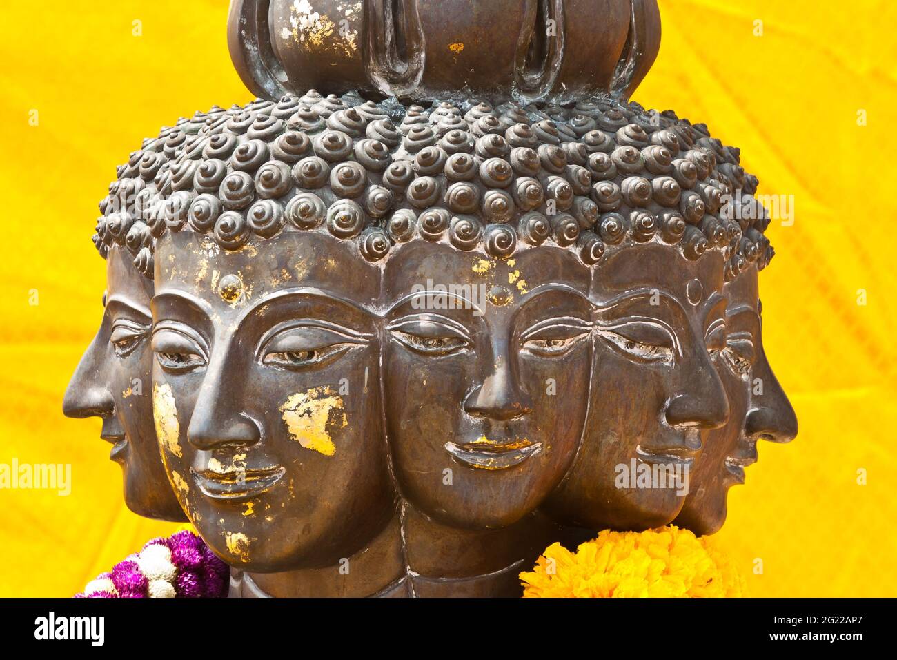 Multi headed metallic buddha head on yellow background, thailand Stock ...