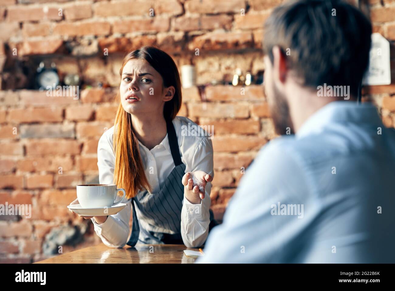 female waiter with a cup of coffee serving customer cafe Stock Photo ...
