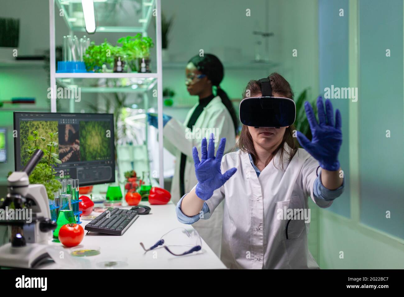 Researcher with virtual reality headset researching new genetic ...