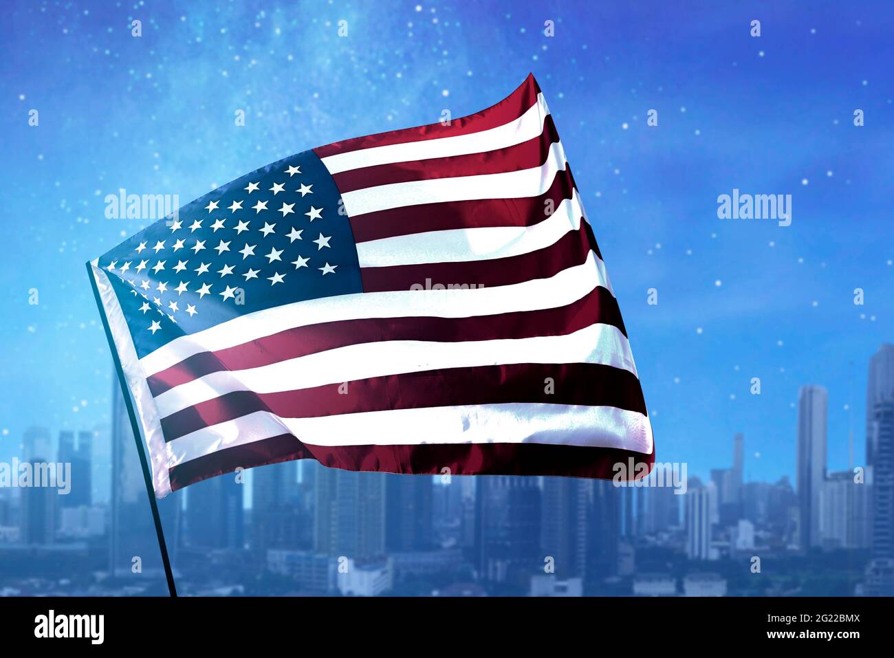 American flag waving in the air with night scene background. Fourth of ...