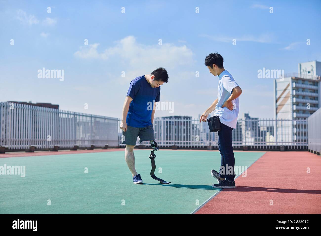 Japanese prosthetist working with amputee on rooftop Stock Photo - Alamy