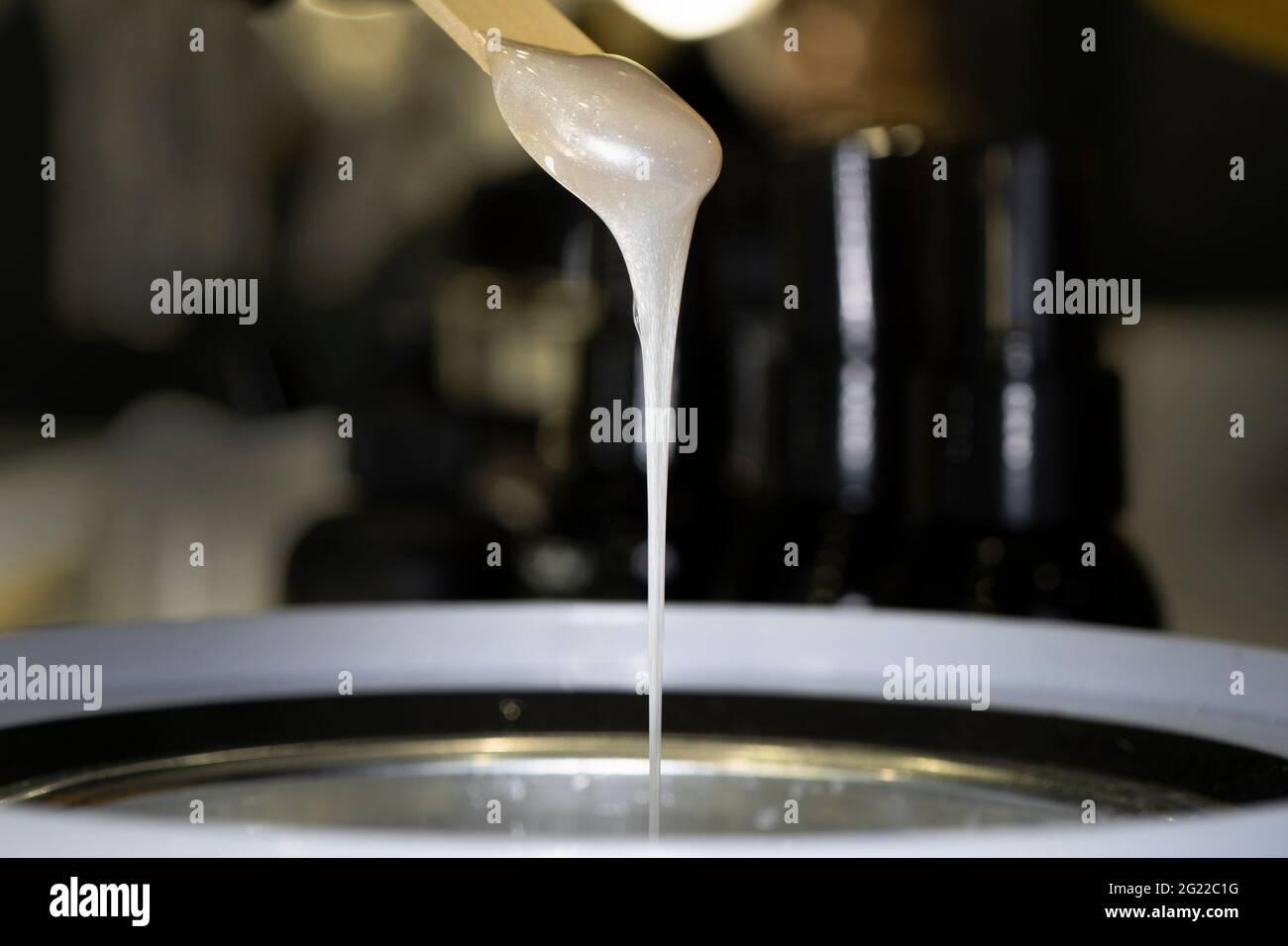 Eyebrow Waxing Procedure. master interferes with a stick with heated ...